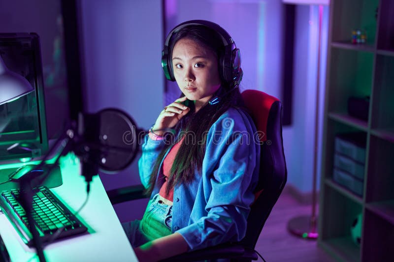 Young Chinese Woman Streamer Playing Video Game Using Computer at ...