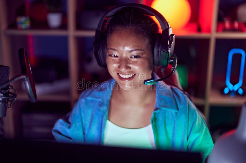 Young Chinese Woman Streamer Playing Video Game Using Computer at ...
