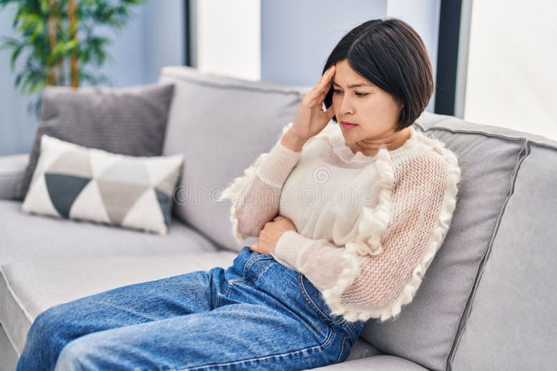 Young Chinese Woman Stressed Sitting on Sofa at Home Stock Photo ...
