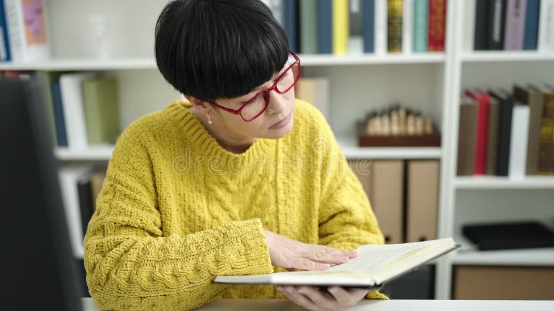 Young Chinese Woman Student Reading Book Studying at Library University ...