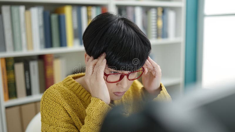 Young Chinese Woman Student Using Computer Stressed at Library ...