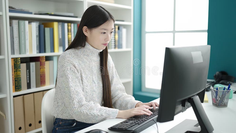 Young Chinese Woman Student Using Computer Studying at Library ...