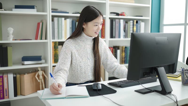 Young Chinese Woman Student Using Computer Writing on Notebook at ...