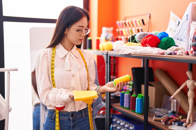 Young Chinese Woman Tailor Holding Cloth and Thread at Atelier Stock ...
