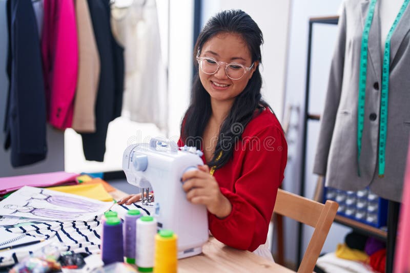 Young Chinese Woman Tailor Smiling Confident Using Sewing Machine at ...