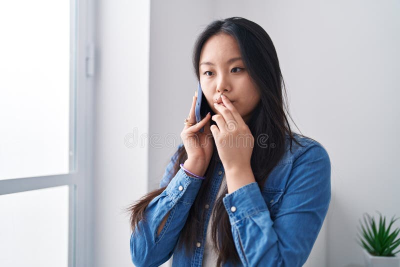 Young Chinese Woman Talking on Smartphone Standing at Home Stock Image ...