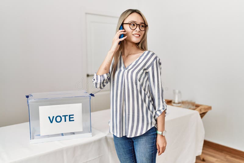 Young Chinese Woman Talking on the Smartphone Voting at Electoral ...