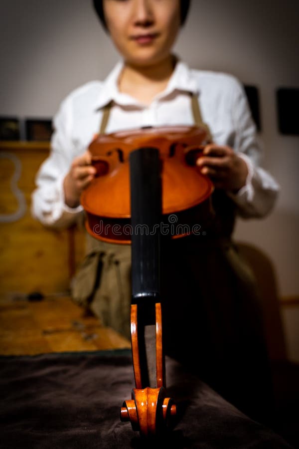 Young Chinese Woman Violin Maker Checking the Quality of Her Violin ...
