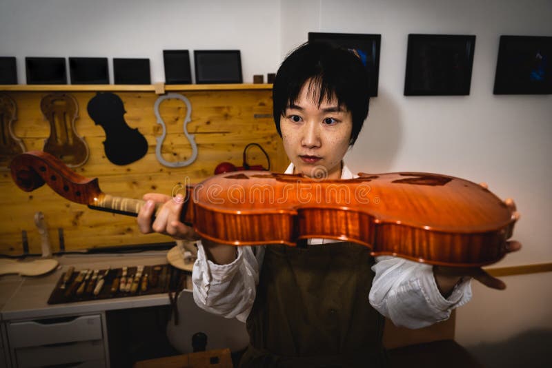 Young Chinese Woman Violin Maker Checking the Quality of Her Violin ...