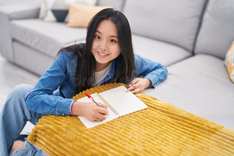 Young Chinese Woman Writing on Notebook Sitting on Floor at Home Stock ...