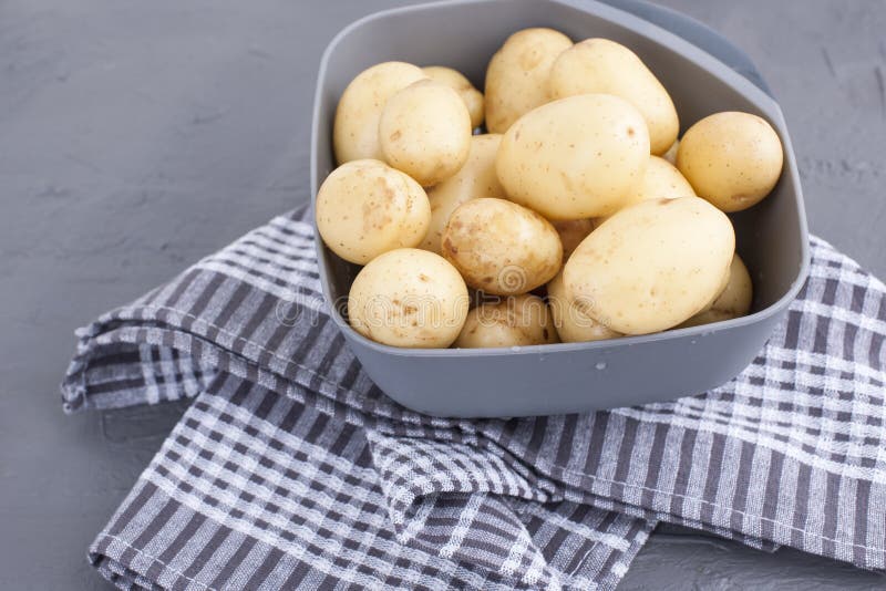 Young Clean Potatoes in a Bowl on the Table and a Kitchen Towel. Copy ...