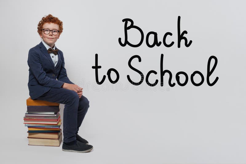 Young Clever Boy Wearing School Uniform Sitting on Stack of Books on ...