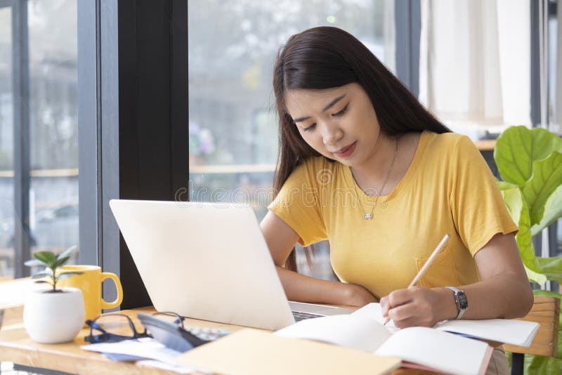 Young Collage Student Using Computer and Mobile Device Studying Online ...