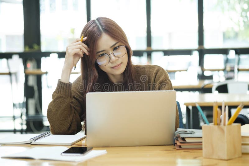 Young Collage Student Using Computer and Mobile Device Studying Online ...