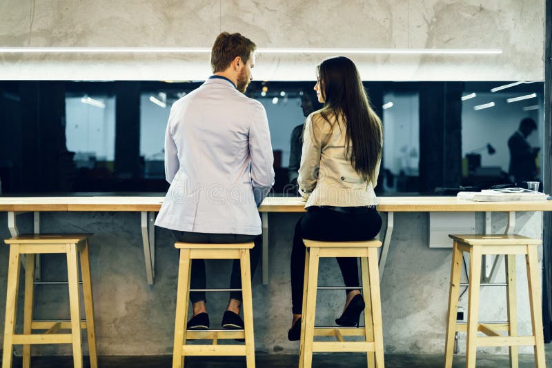 Young Colleagues Conversing during Break Hours Stock Image - Image of ...