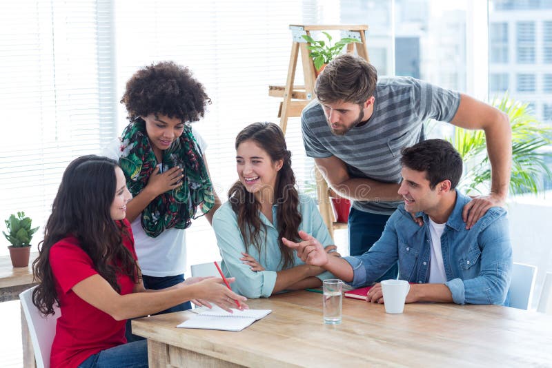 Young Colleagues in Discussion at Office Stock Photo - Image of ...