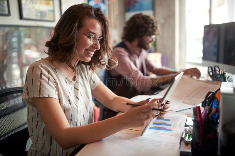 Young Colleagues Doing Paperwork Together Stock Image - Image of ...