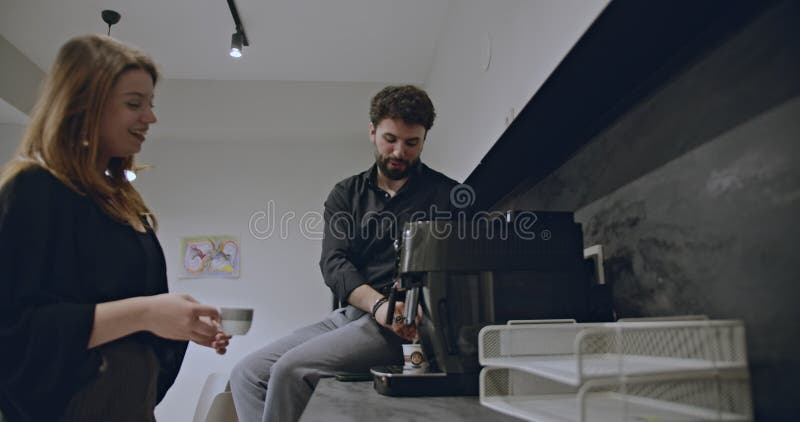 Young Colleagues Enjoying a Casual Conversation by the Coffee Machine ...