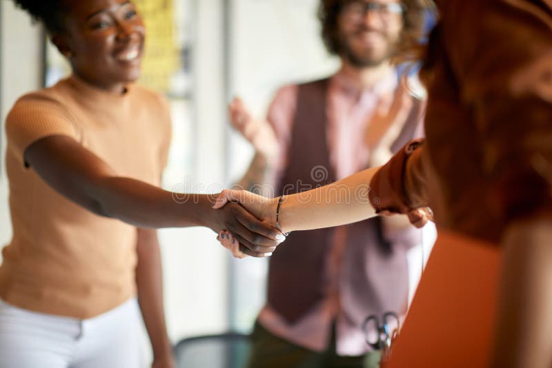 Young Colleagues Shake Hands in the Office Stock Photo - Image of ...