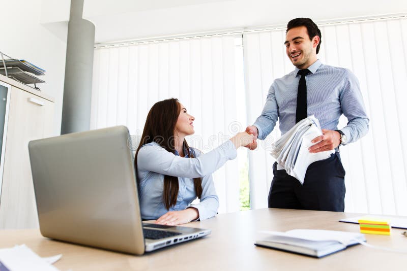 Young Colleagues Shake Hands after a Successful Job Stock Image - Image ...