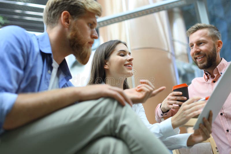Young Colleagues in Smart Casual Wear Working while Spending Time in ...