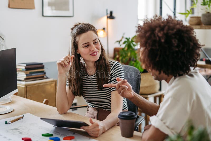 Young Colleagues Working Together in Startup Company. Stock Image ...