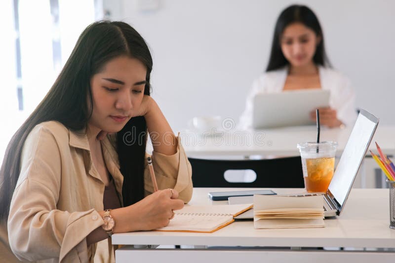 Young College Student Using Computer and Mobile Device Studying Online ...