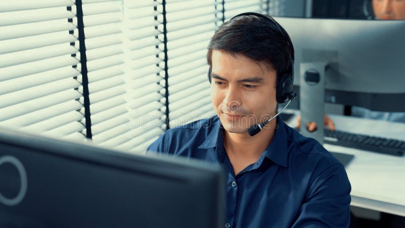 Young Competent Asian Male Call Center Agent Working in the Office ...