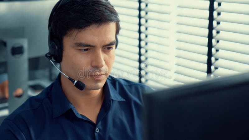 Young Competent Asian Male Call Center Agent Working in the Office ...