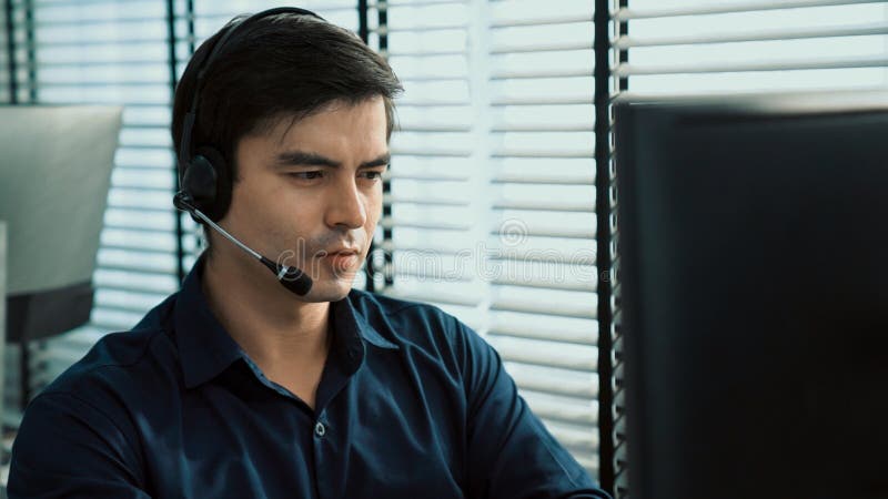 Young Competent Asian Male Call Center Agent Working in the Office ...