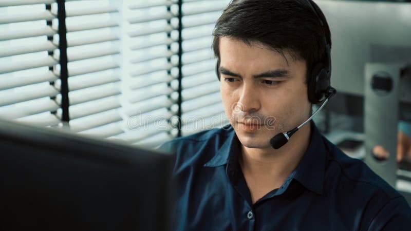 Young Competent Asian Male Call Center Agent Working in the Office ...