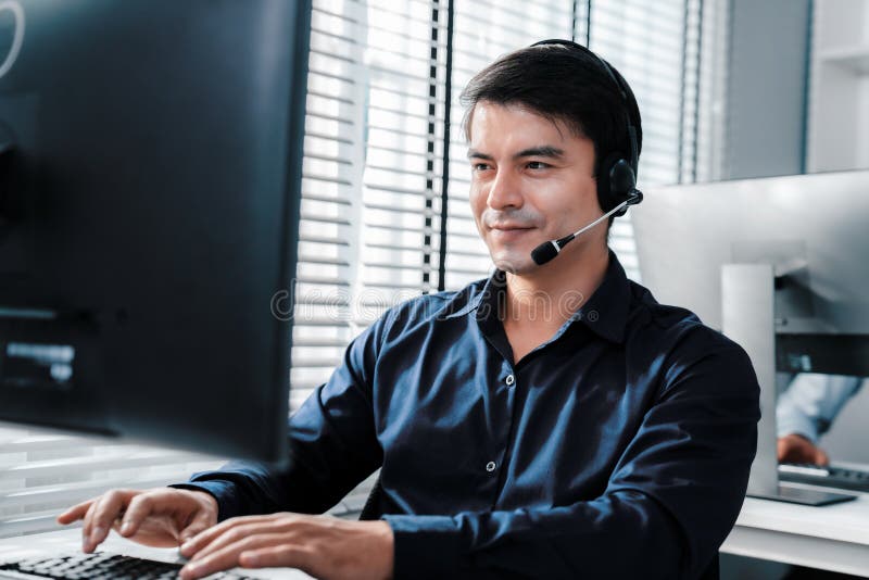Young Competent Asian Male Call Center Agent Working in the Office ...