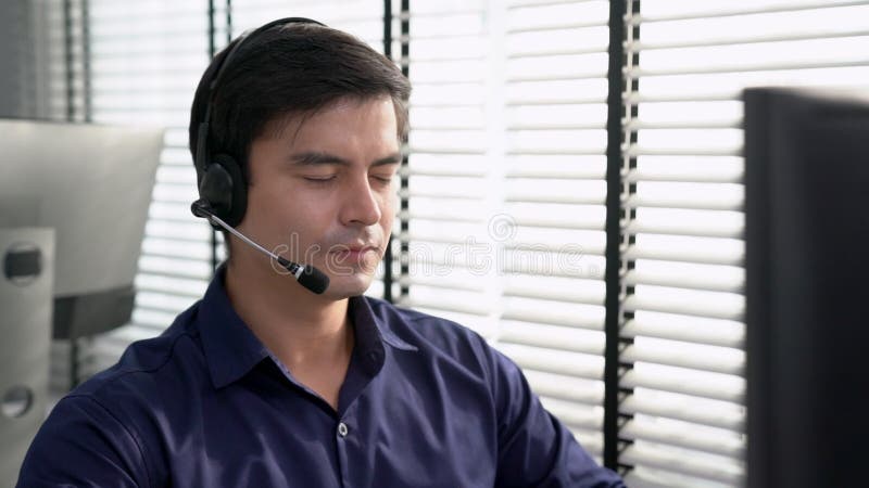 Young Competent Asian Male Call Center Agent Working in the Office ...