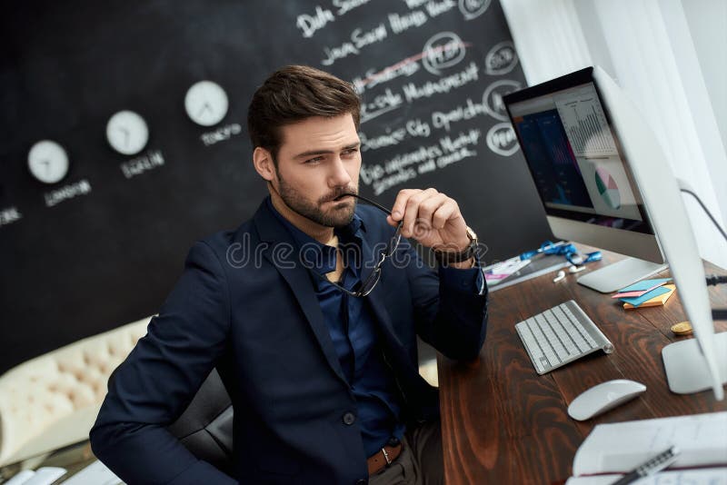 Young Concentrated Businessman or Financial Analyst Looking at Computer ...