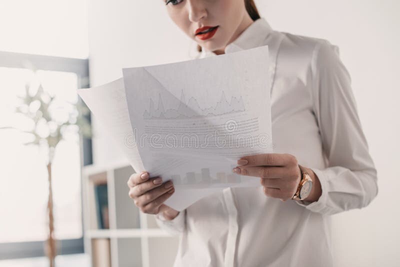 Young Concentrated Businesswoman Reading Documents in Office Stock ...