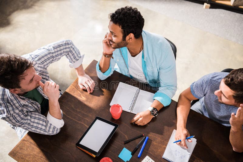 Young Concentrated Men Working on Project at Small Office Meeting Stock ...