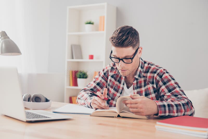Young Concentrated Student Reading Book and Preparing for Lessons Stock ...
