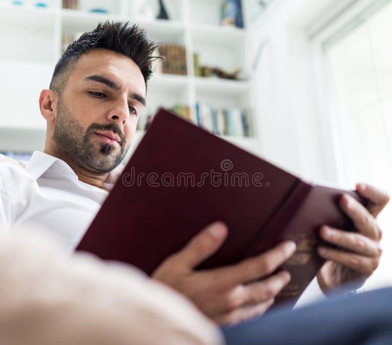 Young Confident Man Reading Book at Home Stock Image - Image of home ...
