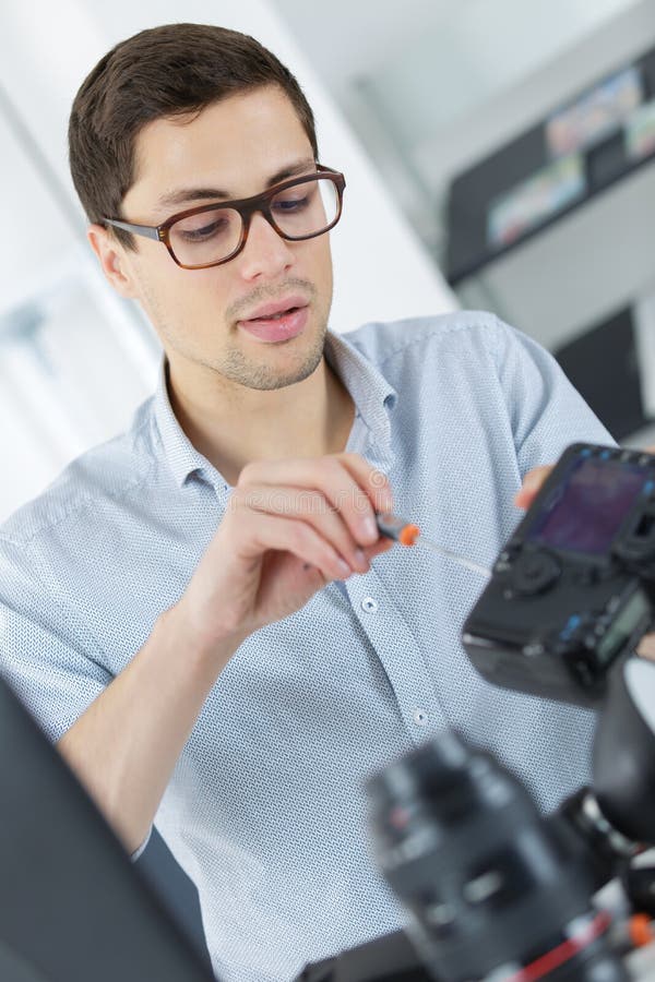 Young Confident Technician Fixing and Cleaning Digital Cameralense ...