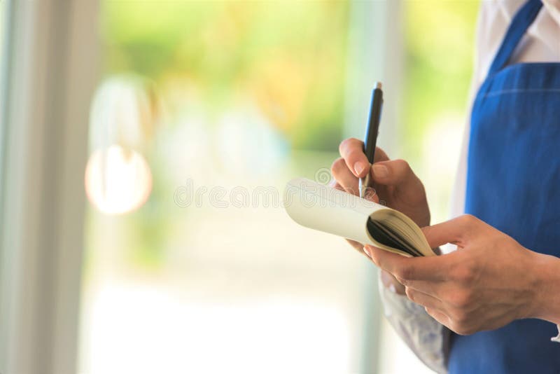 Young Confident Waitress Writing on Notepad at Restaurant Stock Image ...