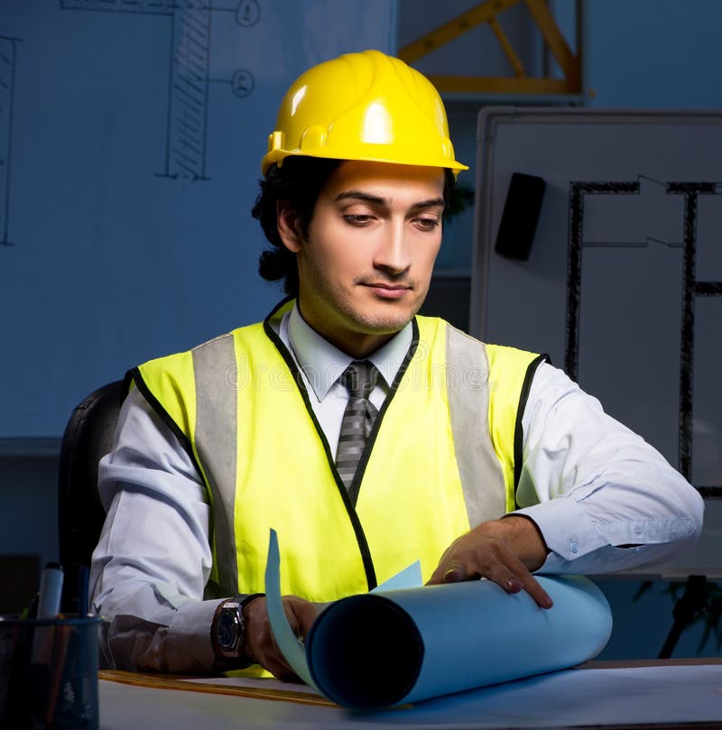 Young Construction Architect Working on Project at Night Stock Photo ...
