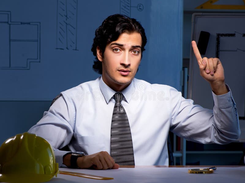 Young Construction Architect Working on Project at Night Stock Photo ...