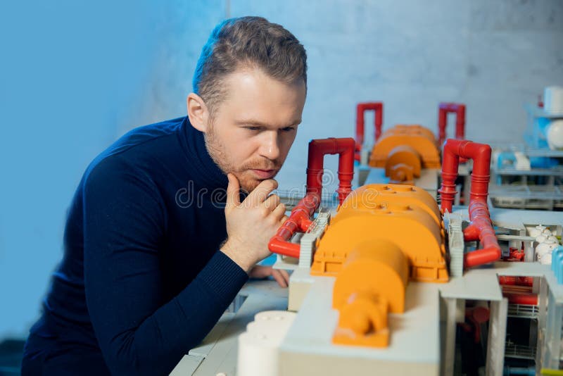 Young Construction Engineer Man is Studying Layout of Structure of ...