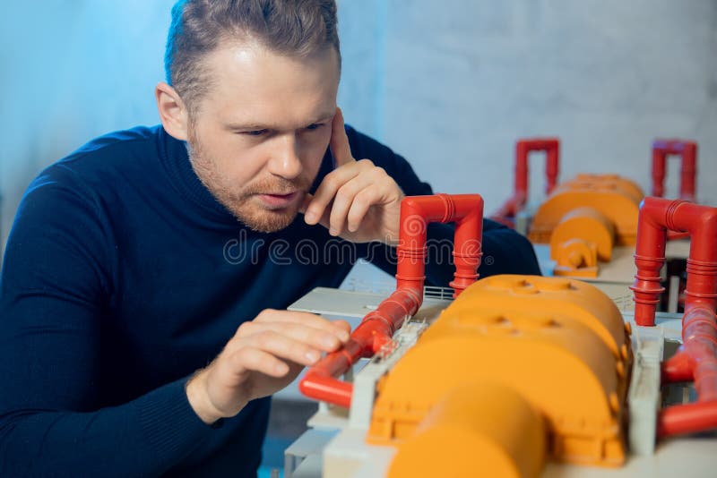 Young Construction Engineer Man is Studying Layout of Structure of ...