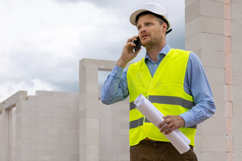 Construction Engineer Supervisor Working at Building Site. Talking on ...