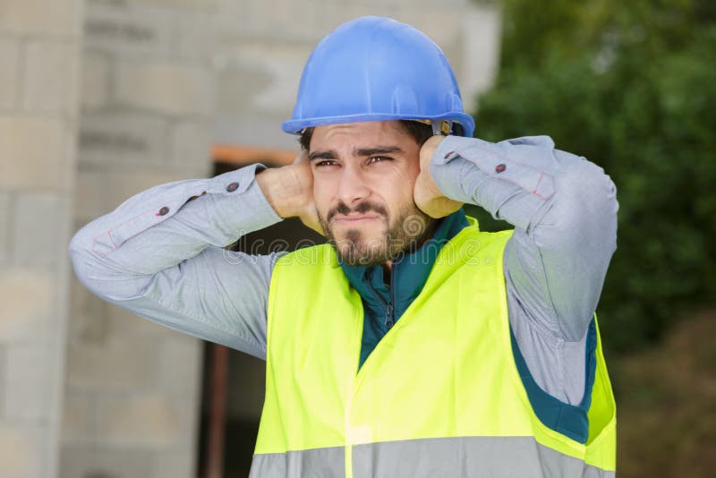 Young Construction Worker Covering Ears Stock Image - Image of nervous ...