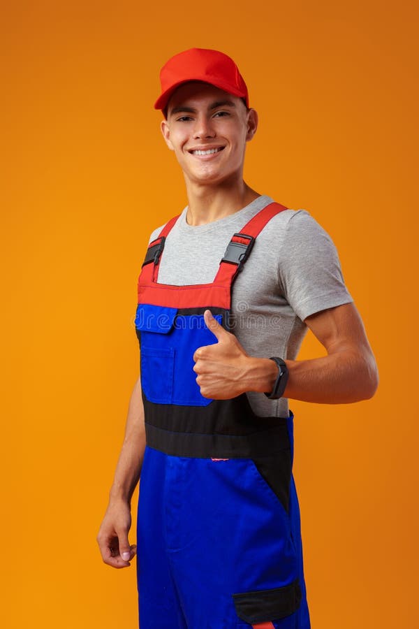 Young Construction Worker in Uniform Posing on Yellow Background in ...