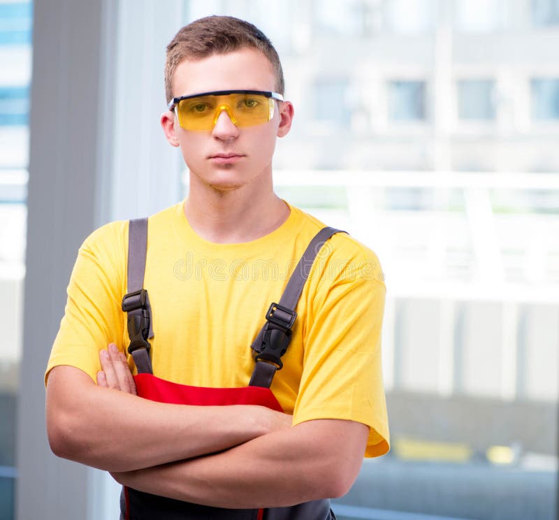 Young Construction Worker in Yellow Coveralls Stock Image - Image of ...