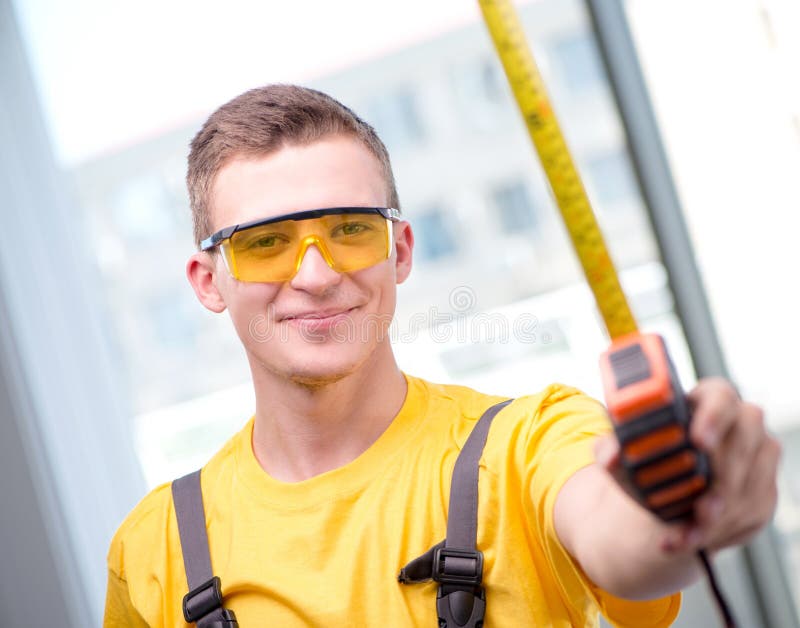 Young Construction Worker in Yellow Coveralls Stock Image - Image of ...