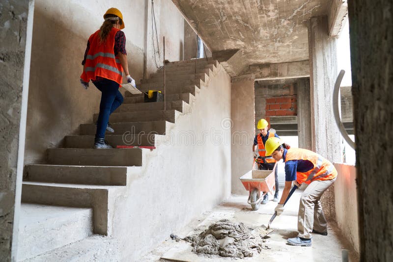 Young Construction Workers Working Together at Incomplete Housing Development Stock Image ...